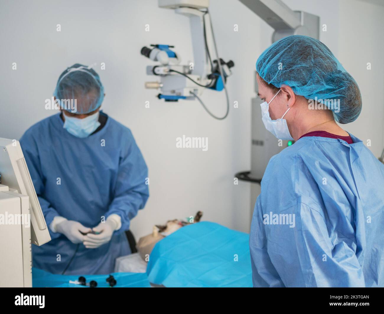 Adult man in mask and medical uniform checking professional near ...