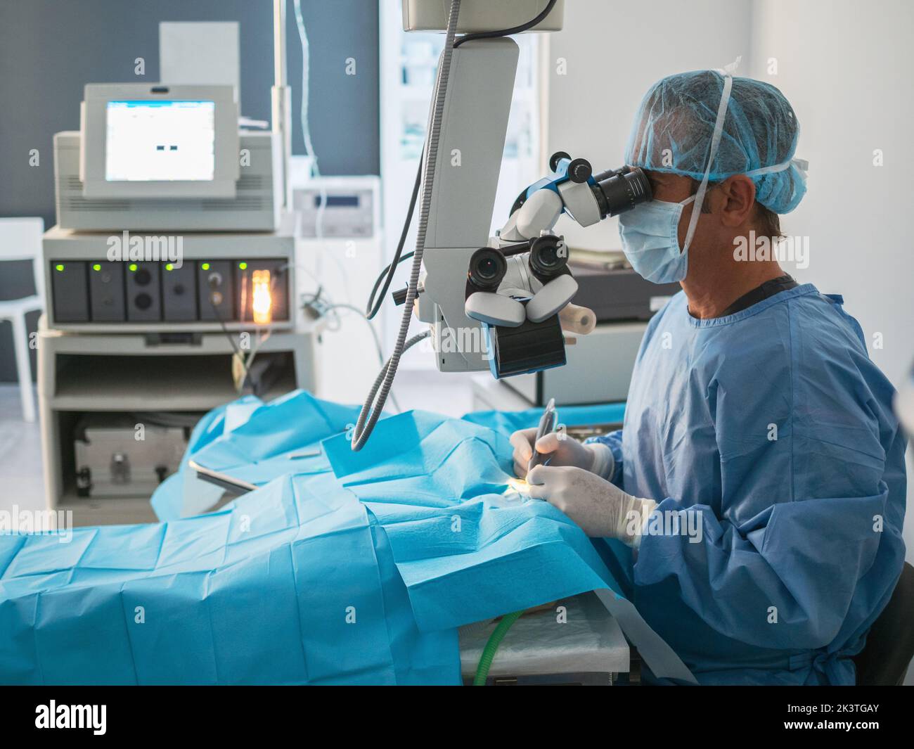 Side view of adult doctor in medical uniform using professional ...