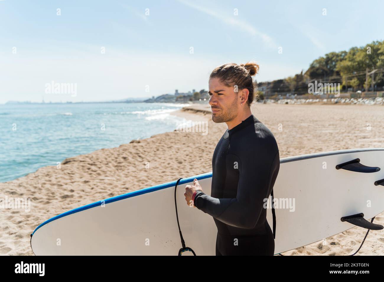 Side view man wetsuit standing surfing board sandy beach hi-res stock ...