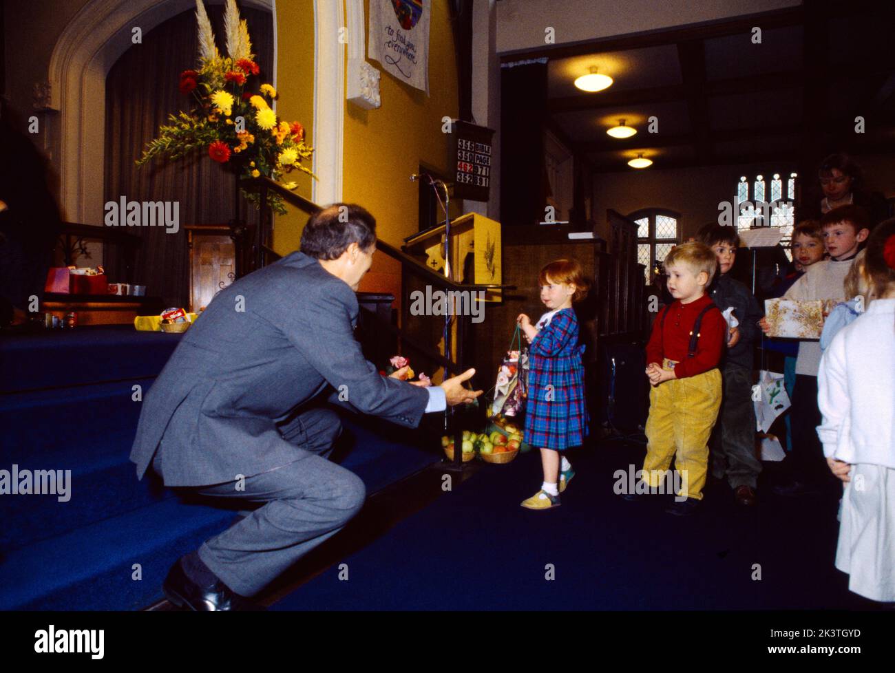 Methodist Church Children Giving Harvest Food at Harvest Festival ...