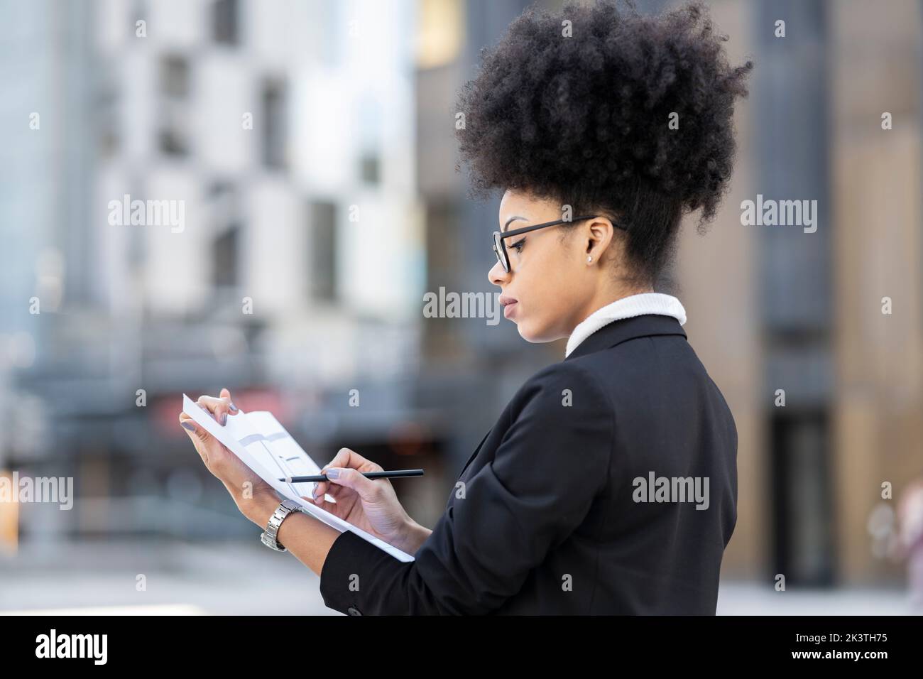 Back view of determined African American female architect in suit ...