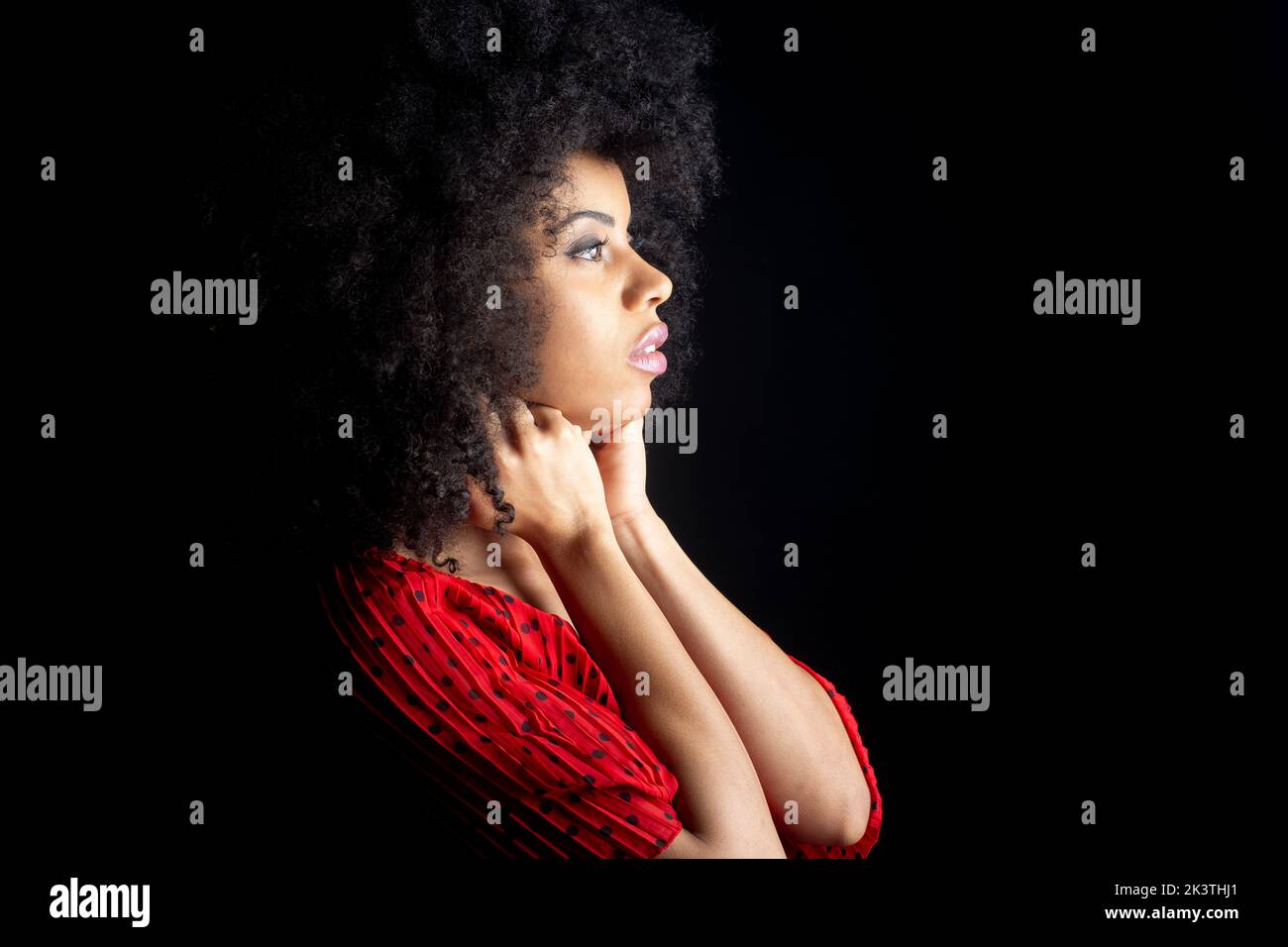 Side view of unemotional thoughtful young ethnic female with afro hair ...