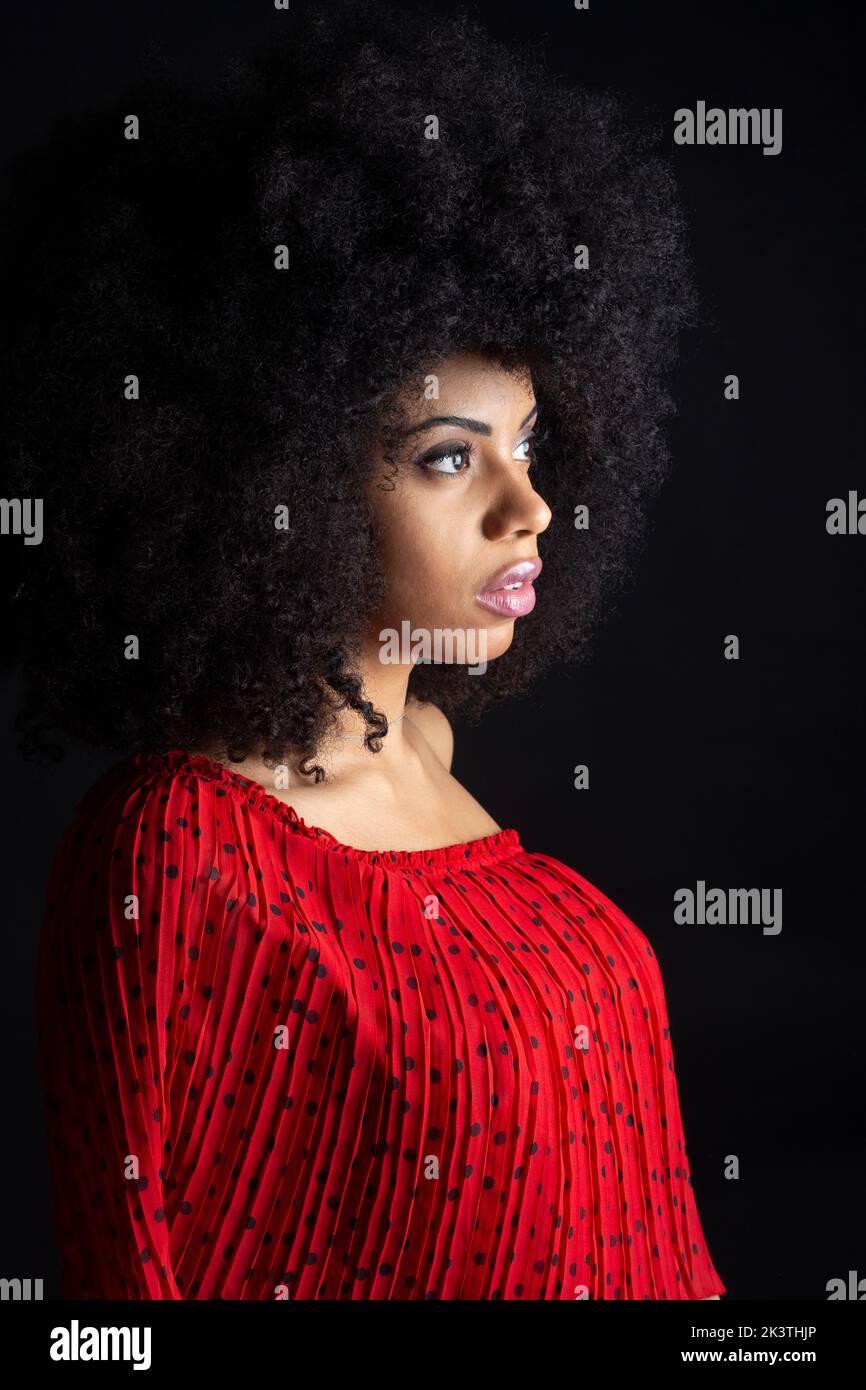 Side view of unemotional thoughtful young ethnic female with afro hair ...