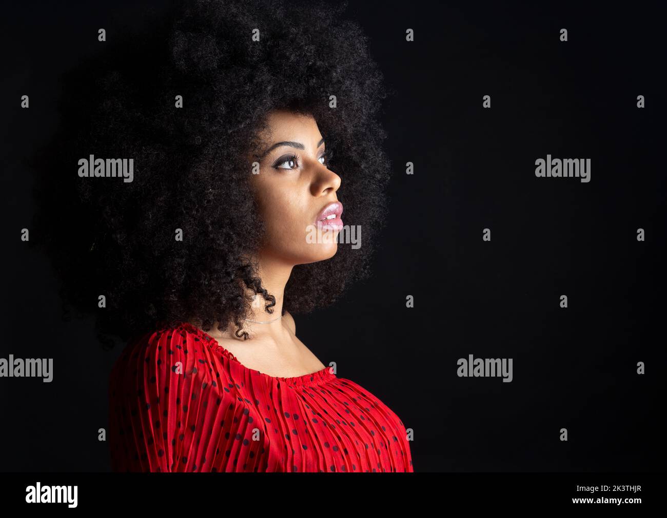 Side view of unemotional thoughtful young ethnic female with afro hair ...