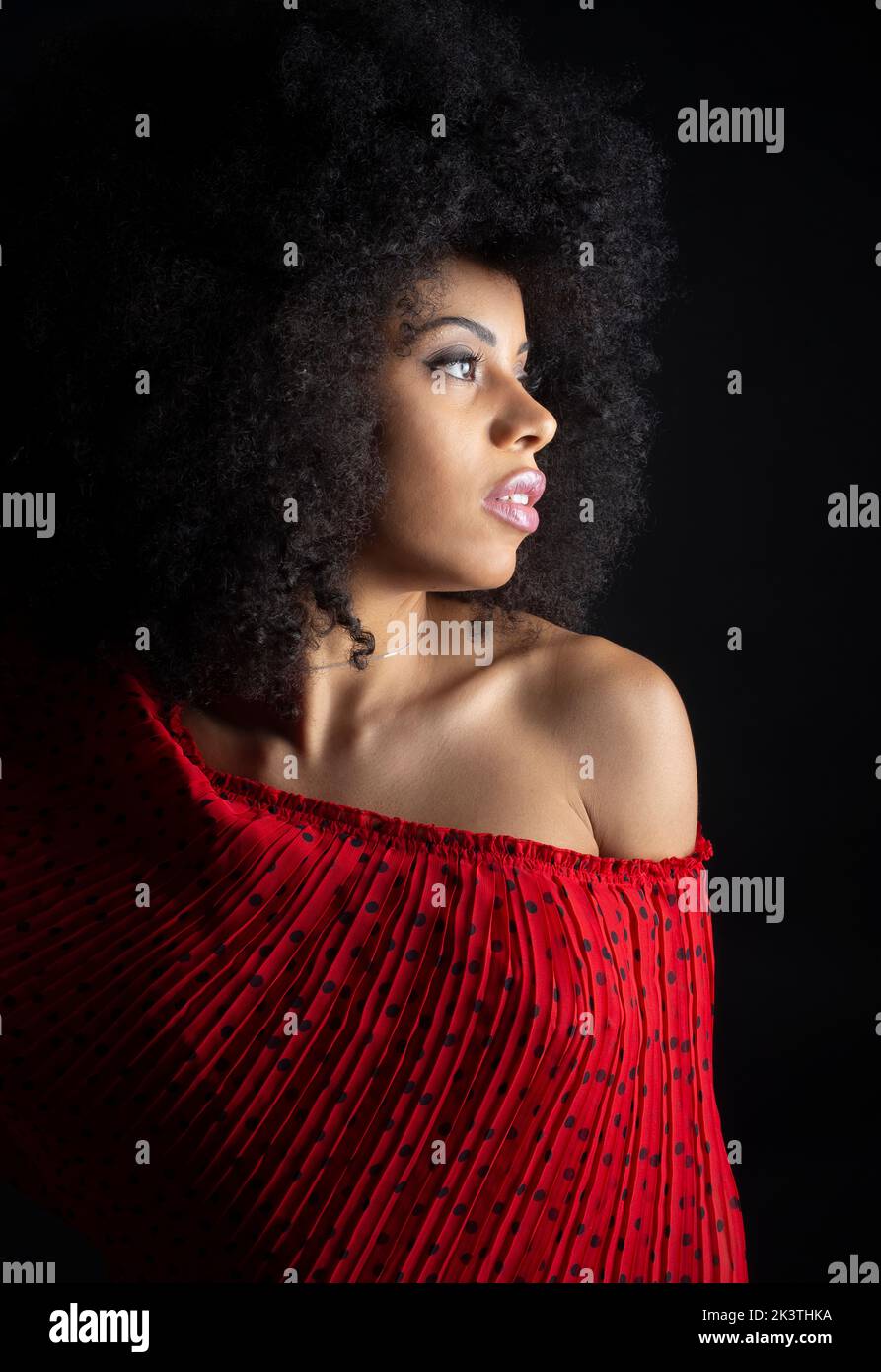 Side view of unemotional thoughtful young ethnic female with afro hair ...