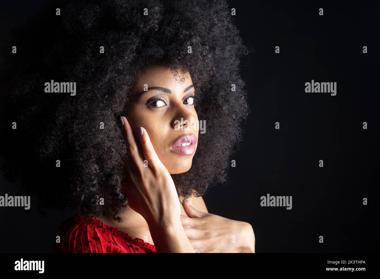 Side view of unemotional young ethnic female with afro hair in ...
