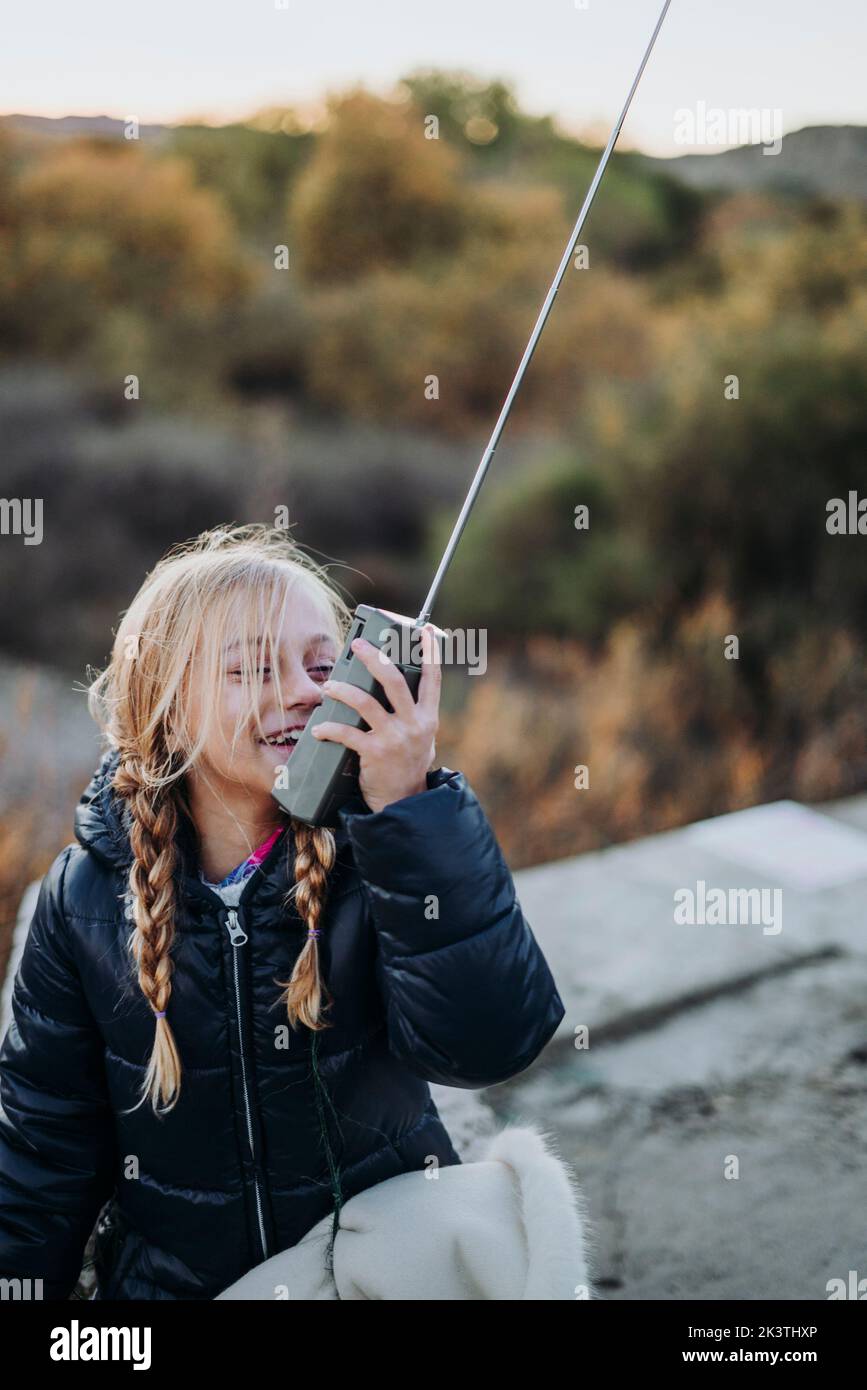 beautiful young girl using a walkie-talkie on forest Stock Photo - Alamy