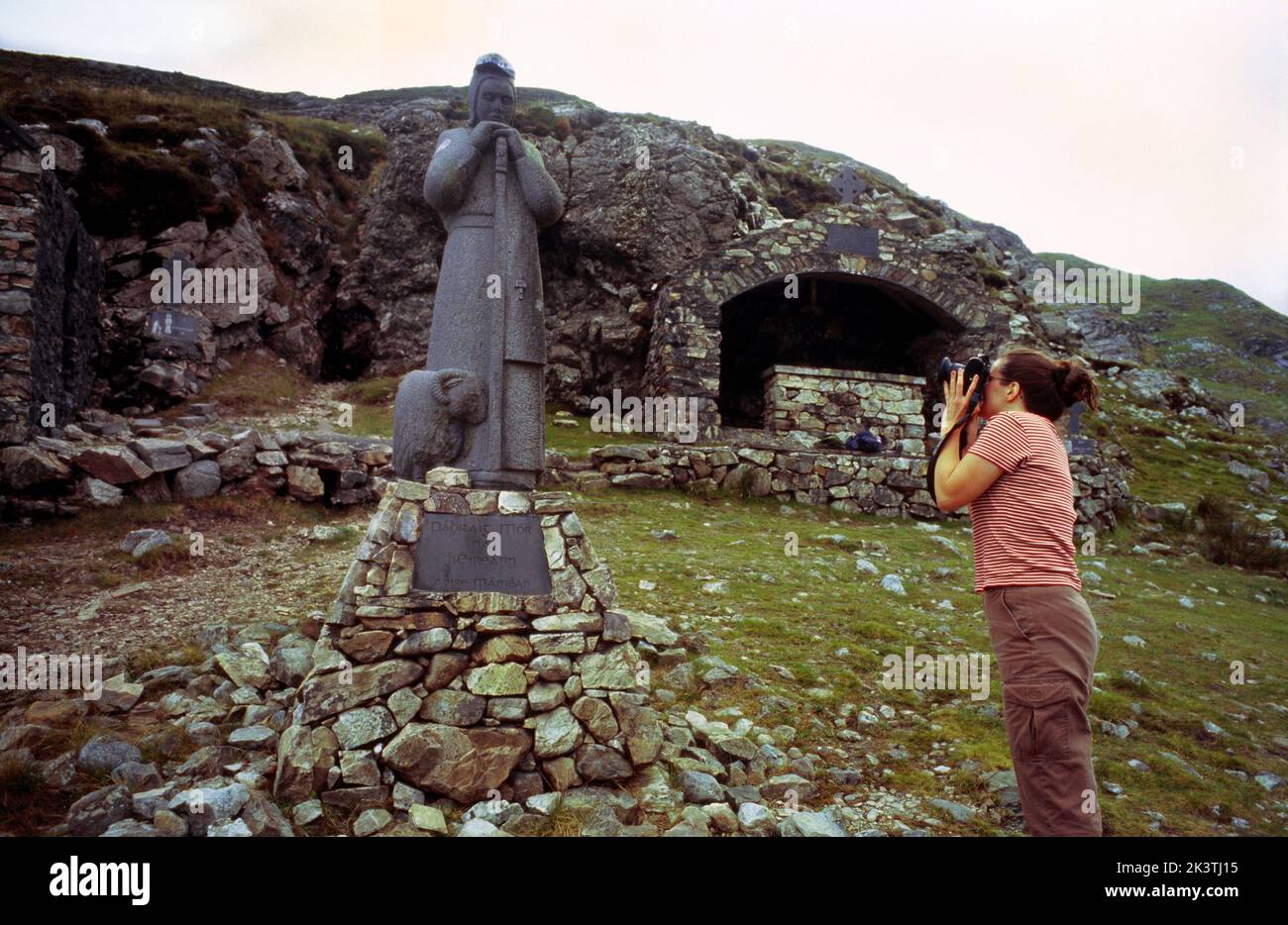 Woman photographing the Statue of St. Patrick Maam Ean Connemara ...