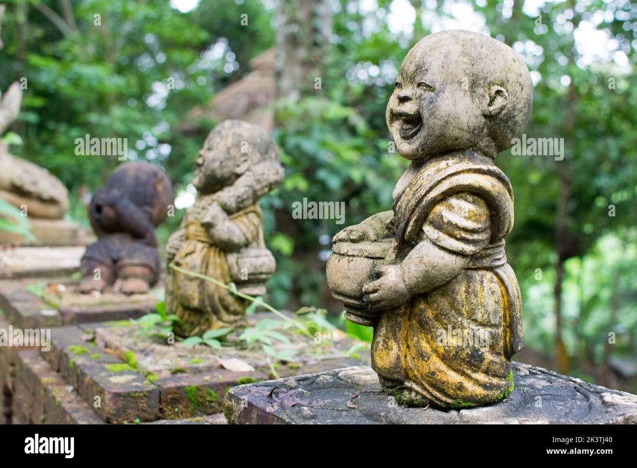 Baby monk Ancient statue in Temple of Thailand Stock Photo - Alamy