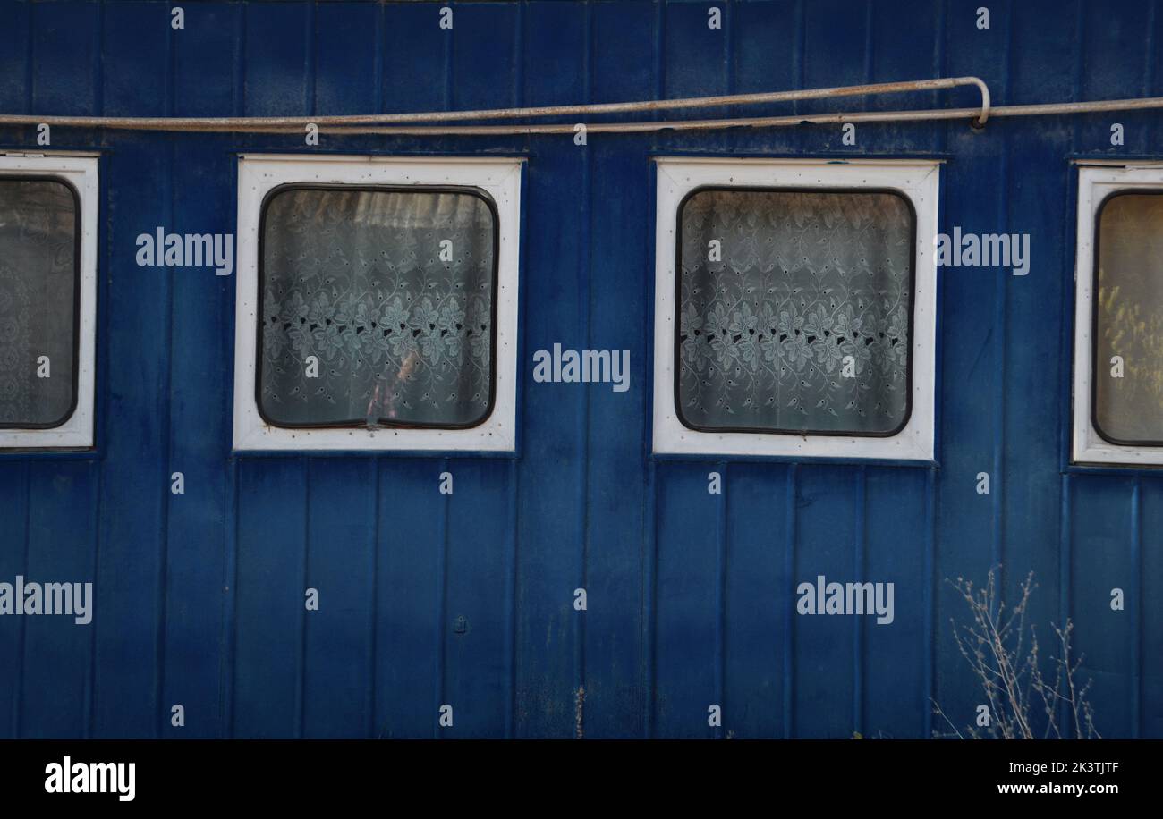 Old square windows on the blue wall Stock Photo - Alamy