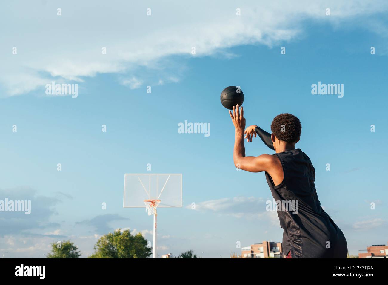 Back view of powerful energetic African American sportsman hanging on ...