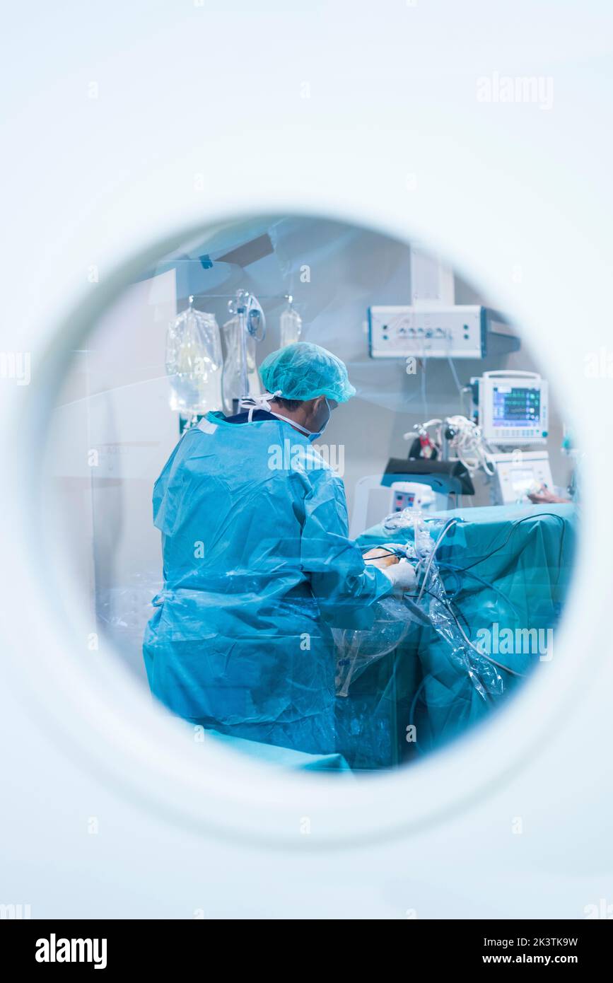 Back view of man in surgeon uniform†performing surgery in modern ...