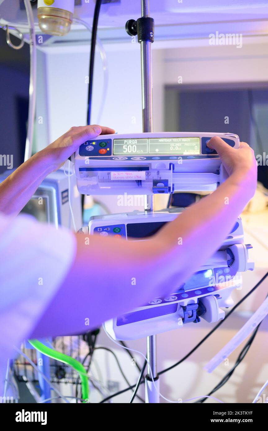Back view of crop unrecognizable woman in white medical scrub is ...