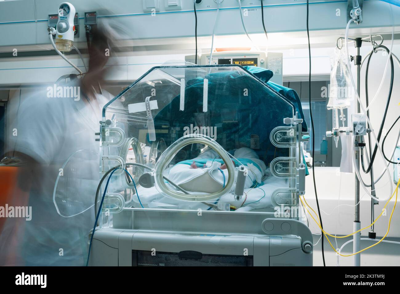 Silhouette anonymous doctor near incubator for newborn in hospital ...