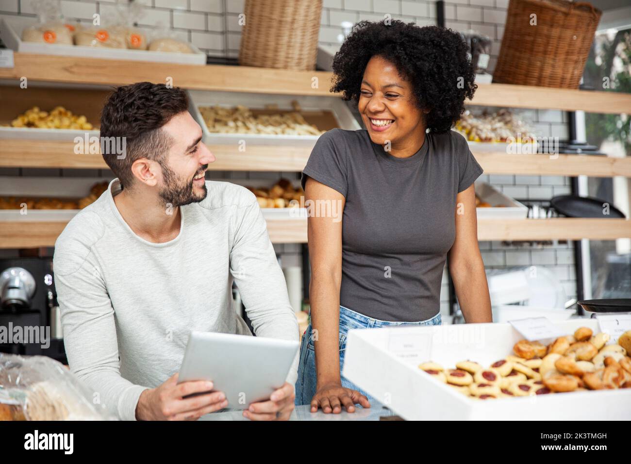 Baker working behind counter hi-res stock photography and images - Alamy