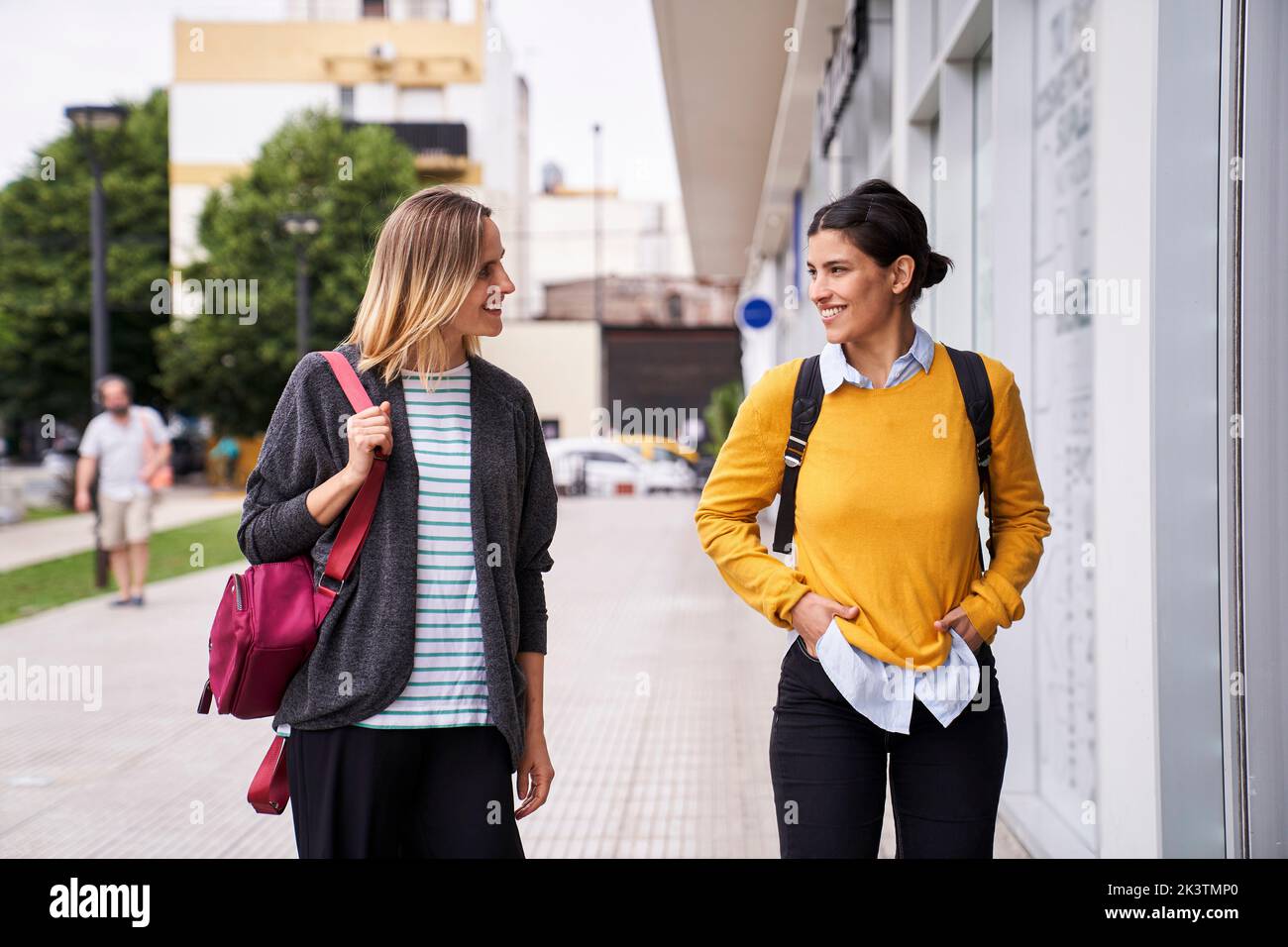 Two happy women going for a walk and window shopping Stock Photo - Alamy