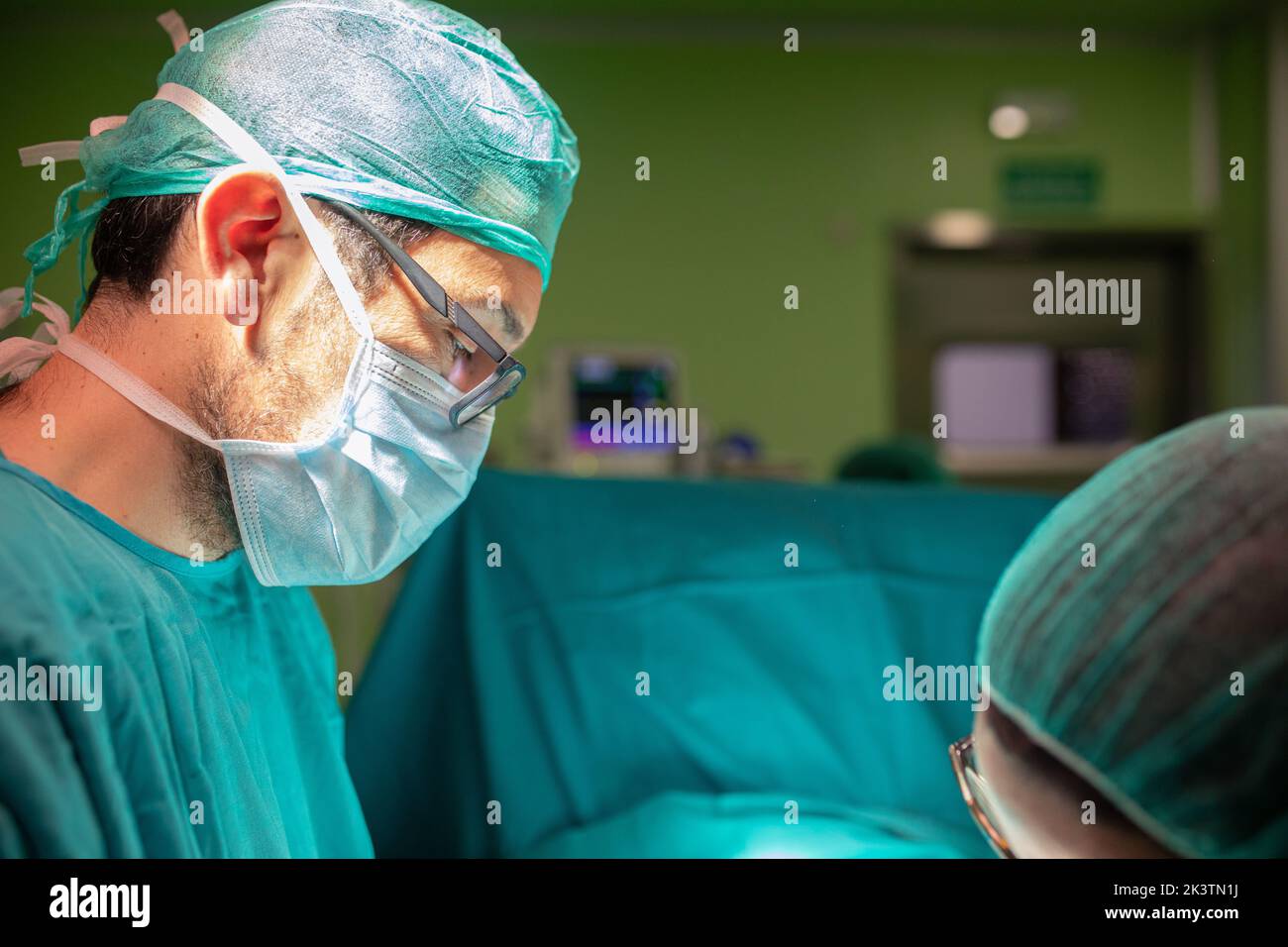 Side view of doctor and assistants in medical uniform performing ...