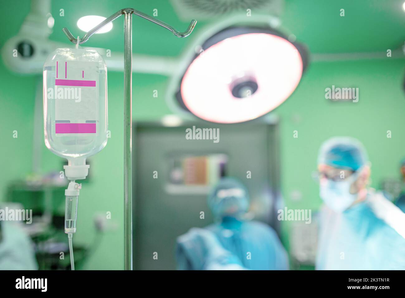 Drip bag with anesthesia drug hanging on stand during surgery on ...