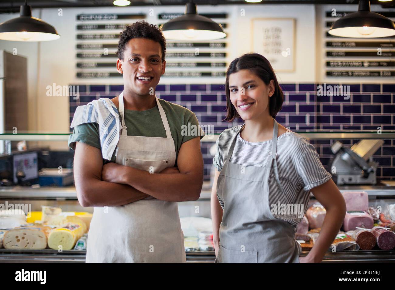 Grocery store owners looking at the camera Stock Photo - Alamy