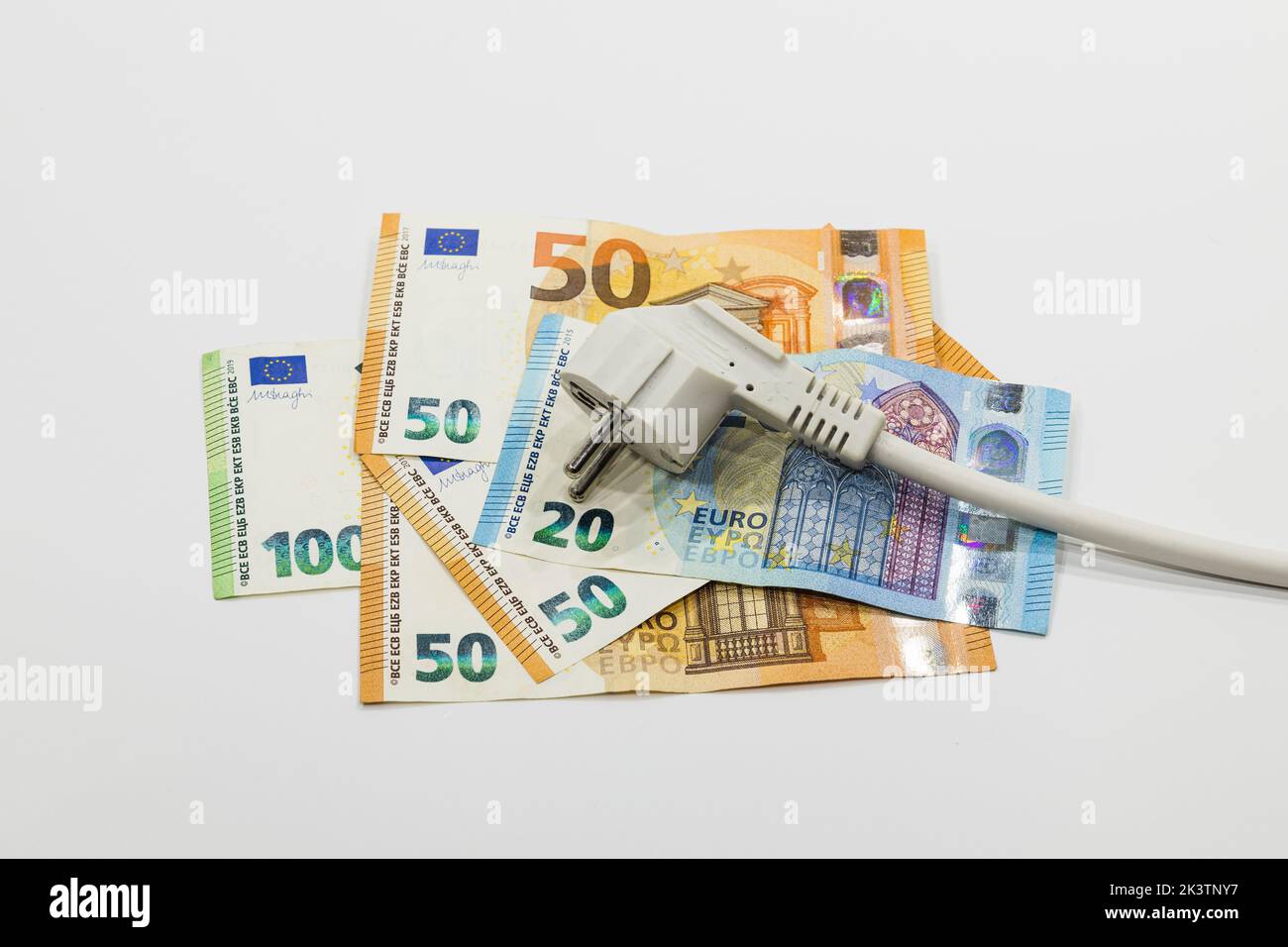 The electric power plug on Euro banknotes. Concept of expensive ...