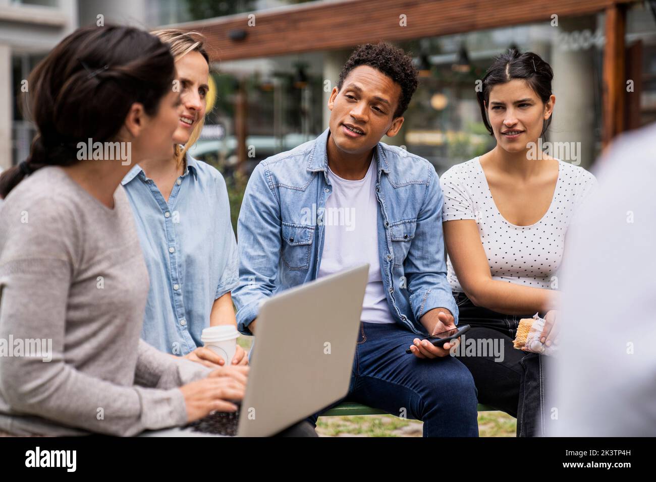 Mid-shot front view of busy remote workers using mobile technology to ...