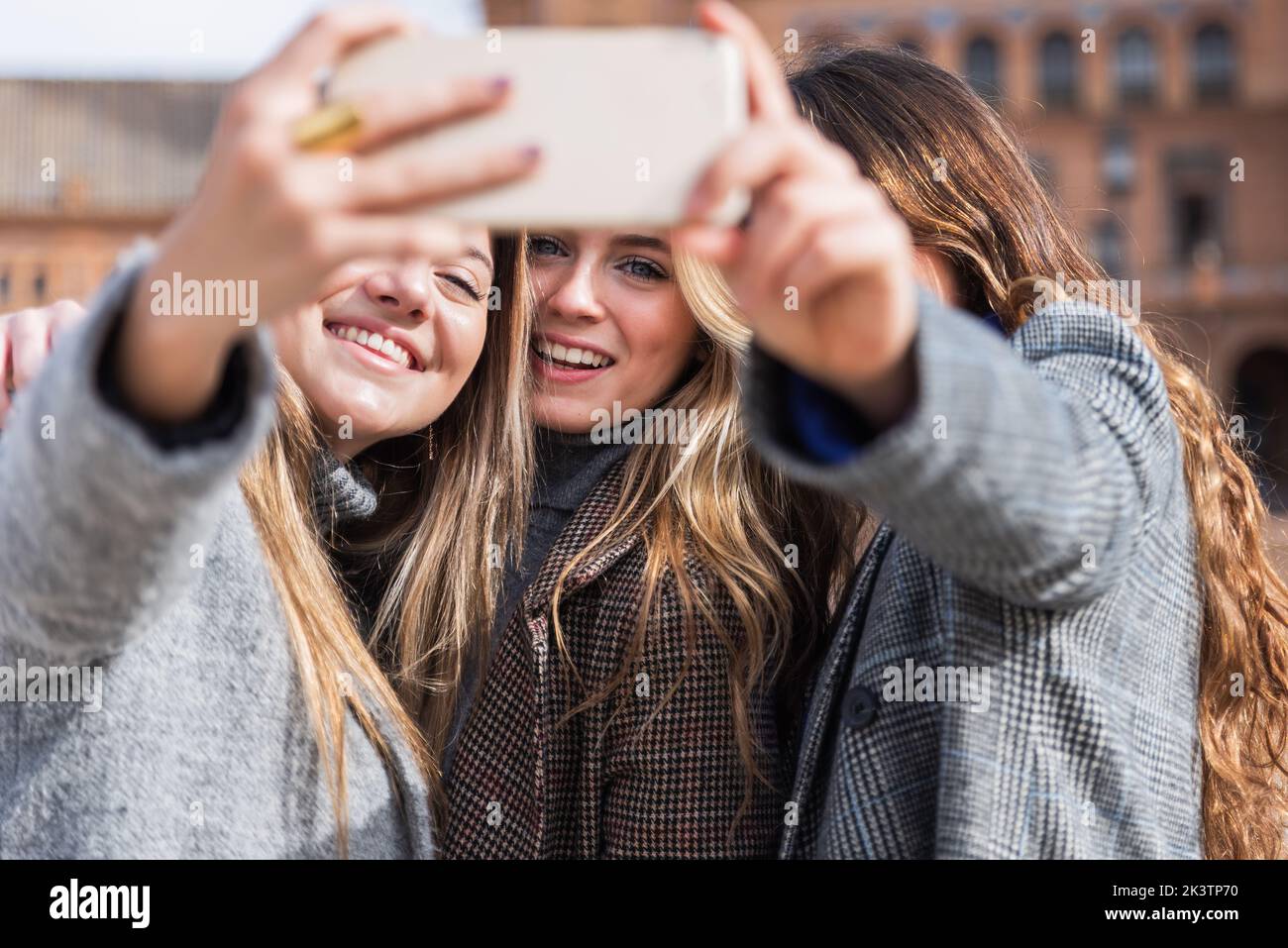 Back view of group of unrecognizable females in stylish outfit taking ...