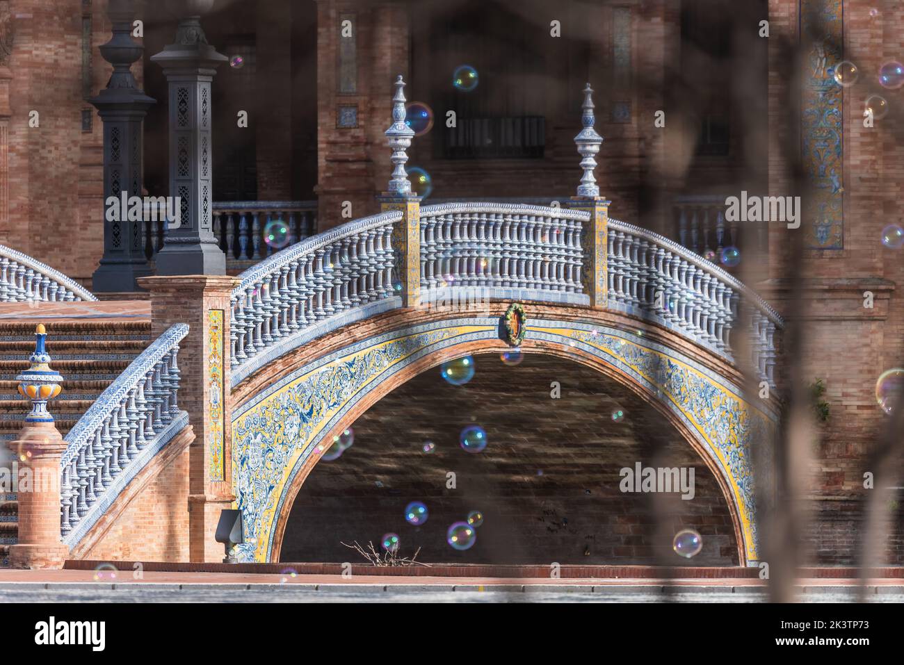 Soap bubbles flying near bridge with stairs located on Plaza de Espana ...