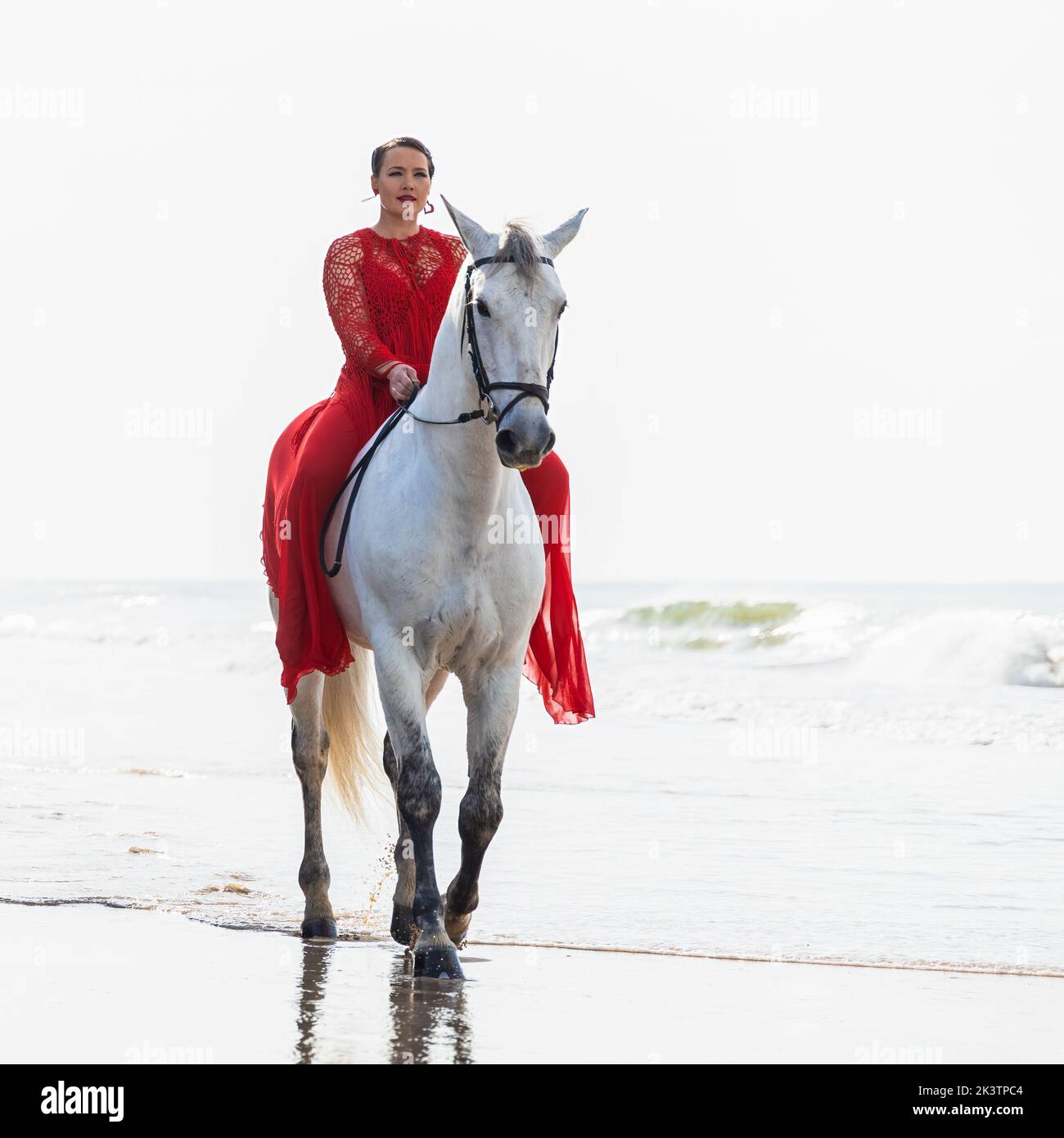 Woman in red dress riding horse hi-res stock photography and images - Alamy