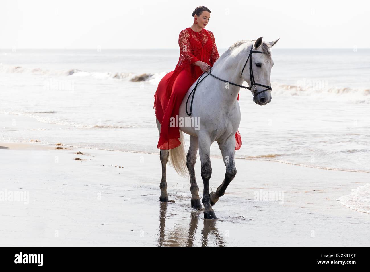 Woman in red dress riding horse hi-res stock photography and images - Alamy