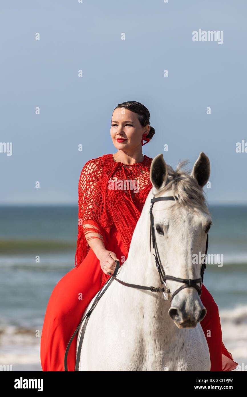 Woman in red dress riding horse hi-res stock photography and images - Alamy