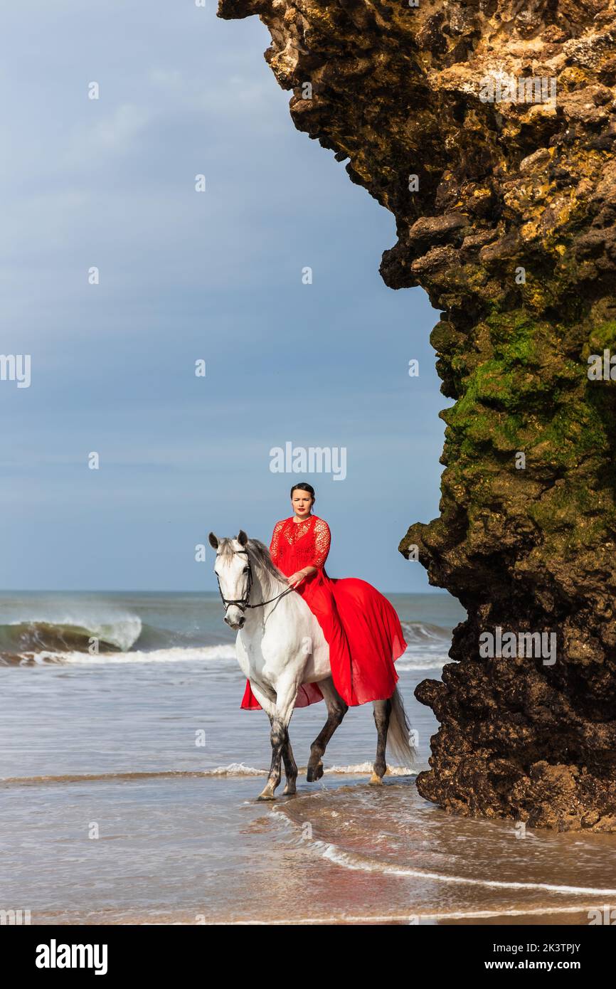 Woman in red dress riding horse hi-res stock photography and images - Alamy