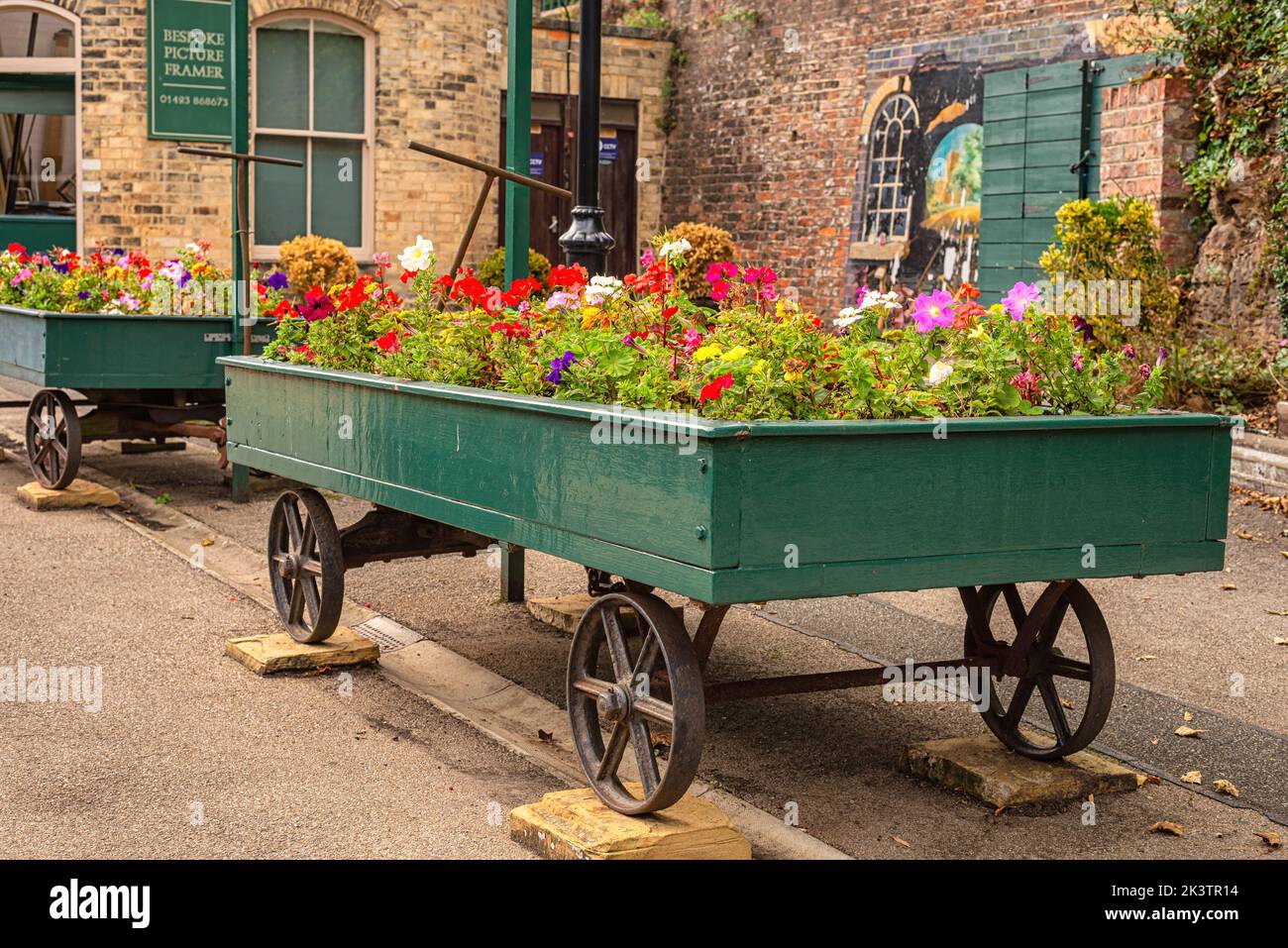 An old railway station trolley has been adapted as a flower bed with a ...