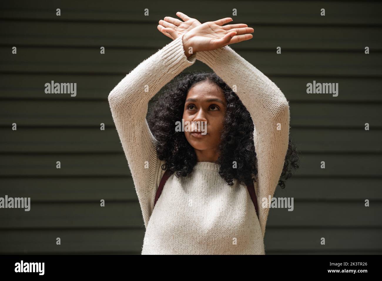 Adult ethnic female with curly hair looking away in village of Monte ...