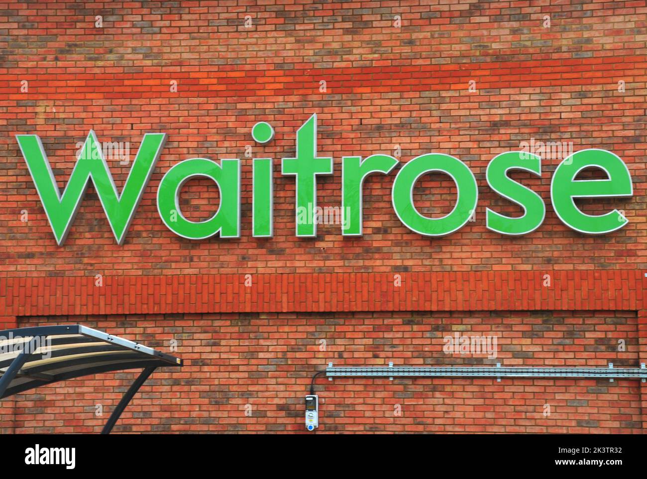 Green Waitrose supermarket sign on brick wall Stock Photo - Alamy