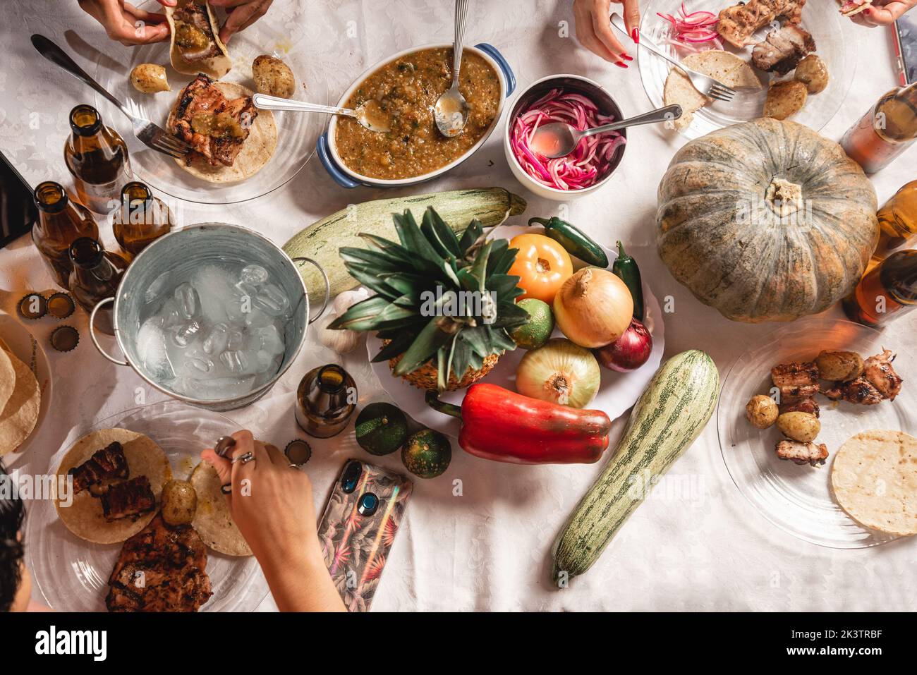 From above of crop anonymous group of friends eating tasty meal while ...