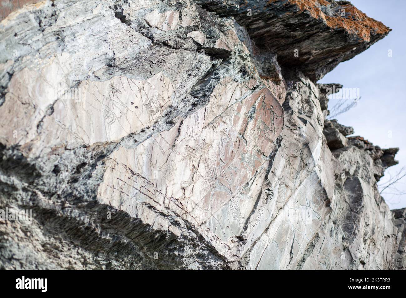 Old rock carvings of an ancient man on rocks in Siberia. The drawings ...