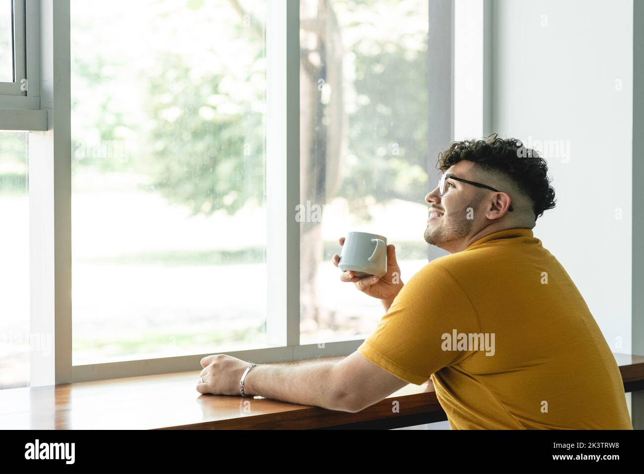 Side view of male employee drinking beverage while having coffee break ...