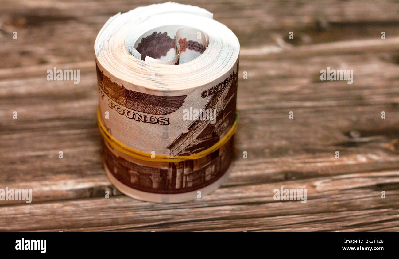 Egypt money roll pounds isolated on wooden background, 50 LE fifty ...