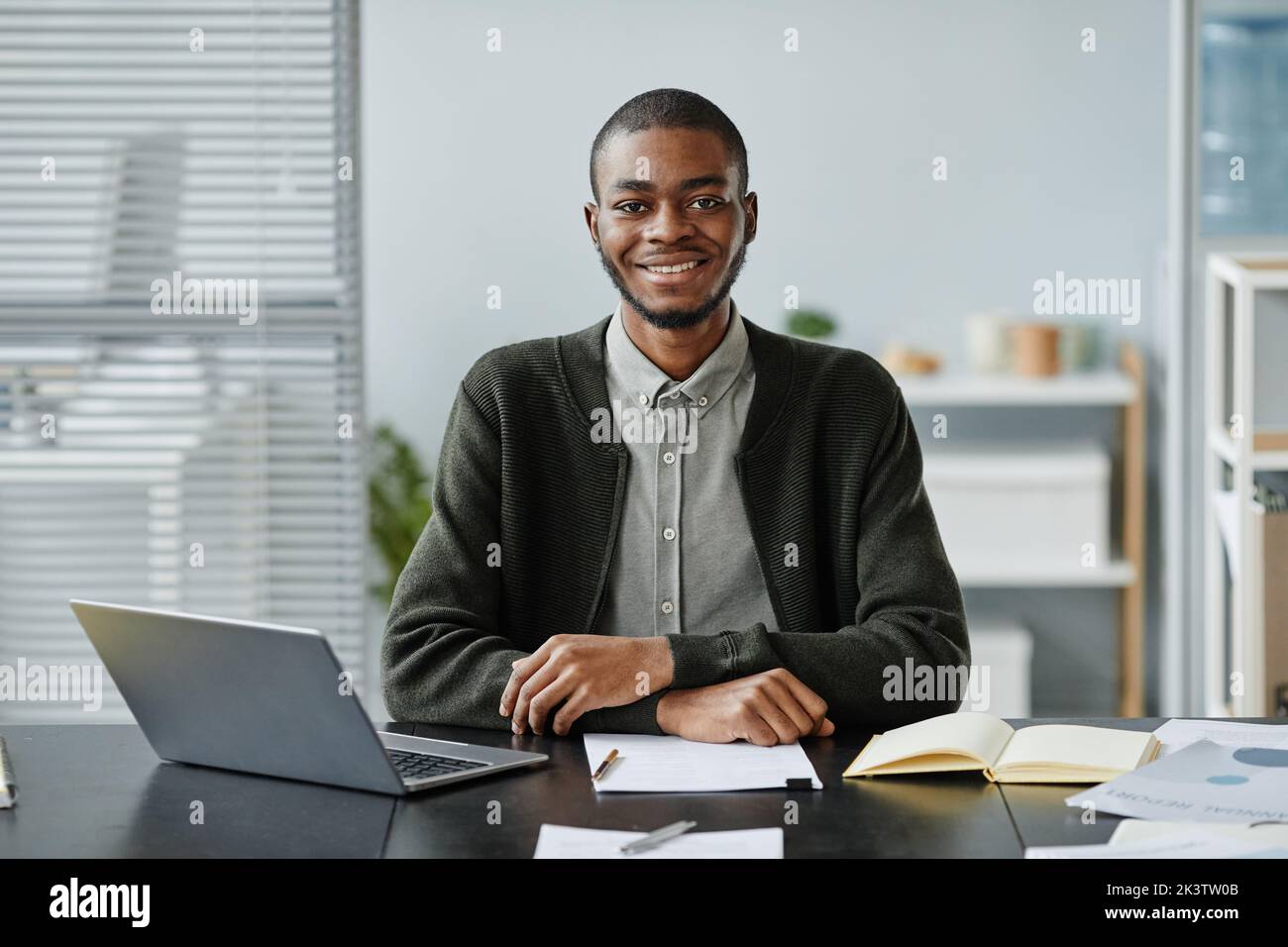 Front view portrait of young black man smiling at camera in job ...