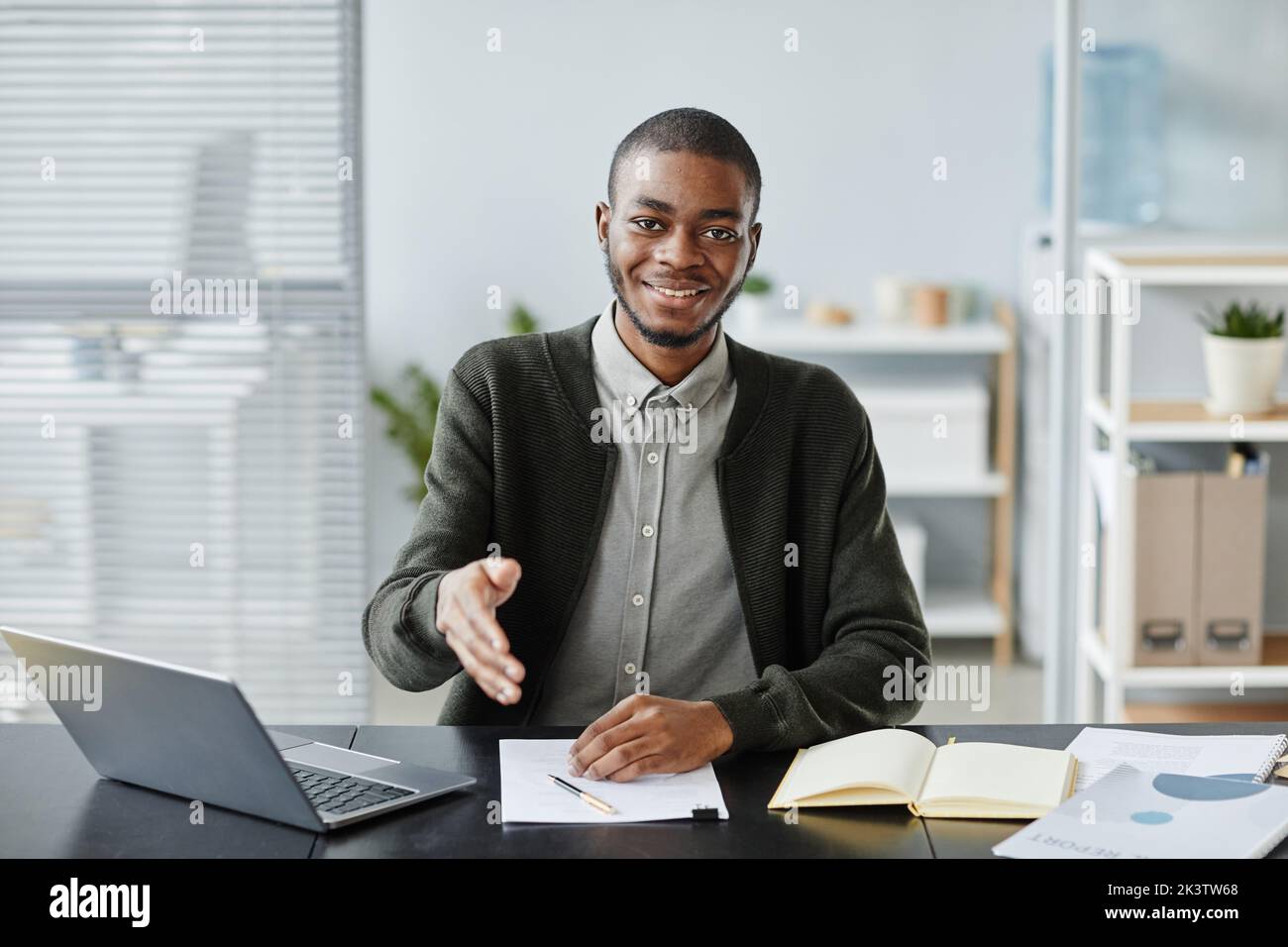 Front view portrait of young black man smiling at camera in job ...