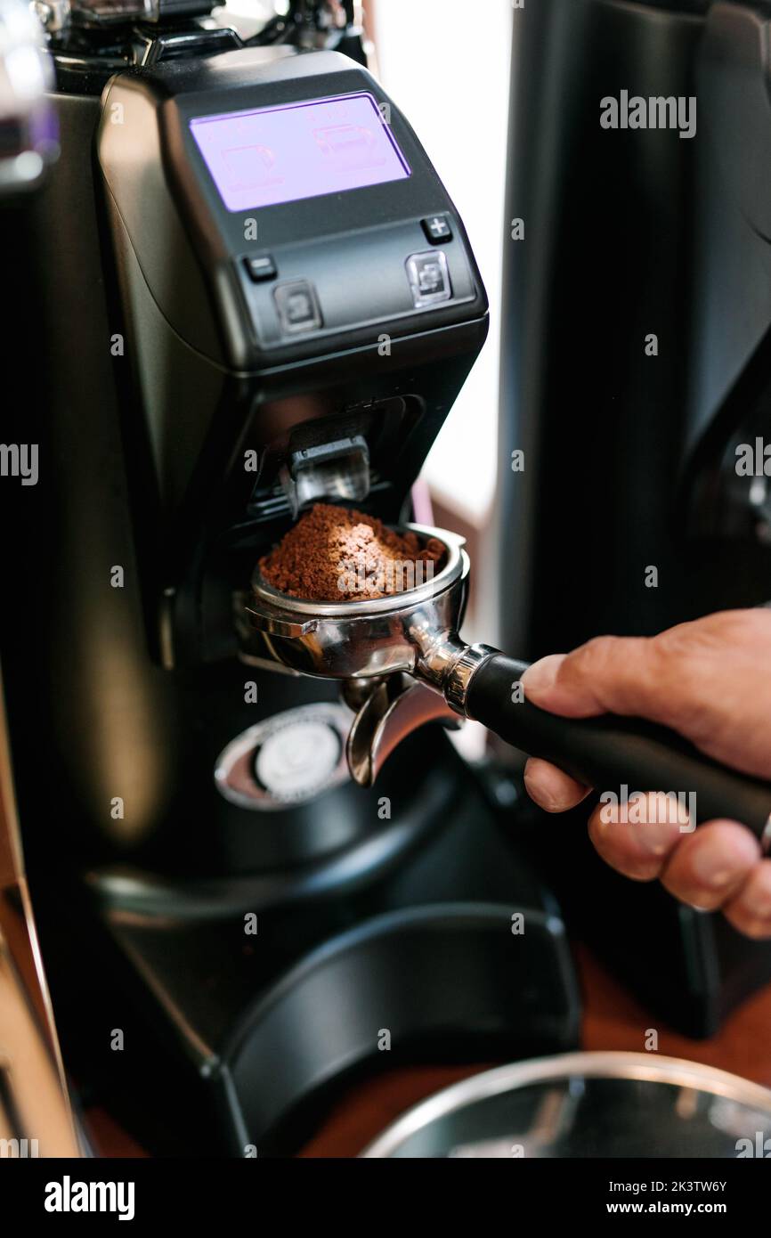 From above freshly aromatic coffee in compartment at coffee machine in ...