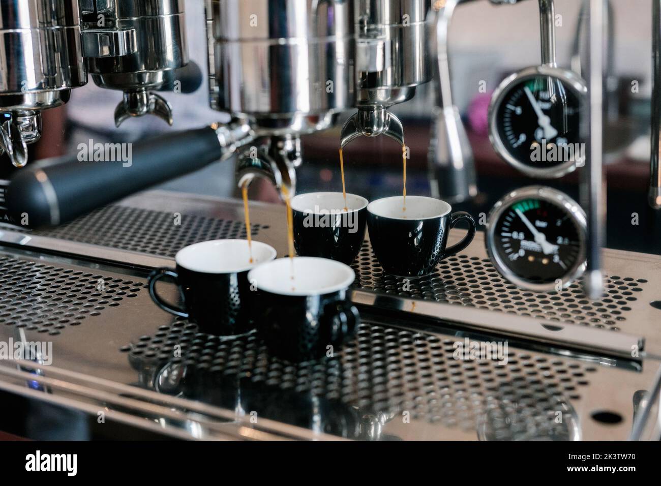 From above freshly aromatic coffee in compartment at coffee machine ...