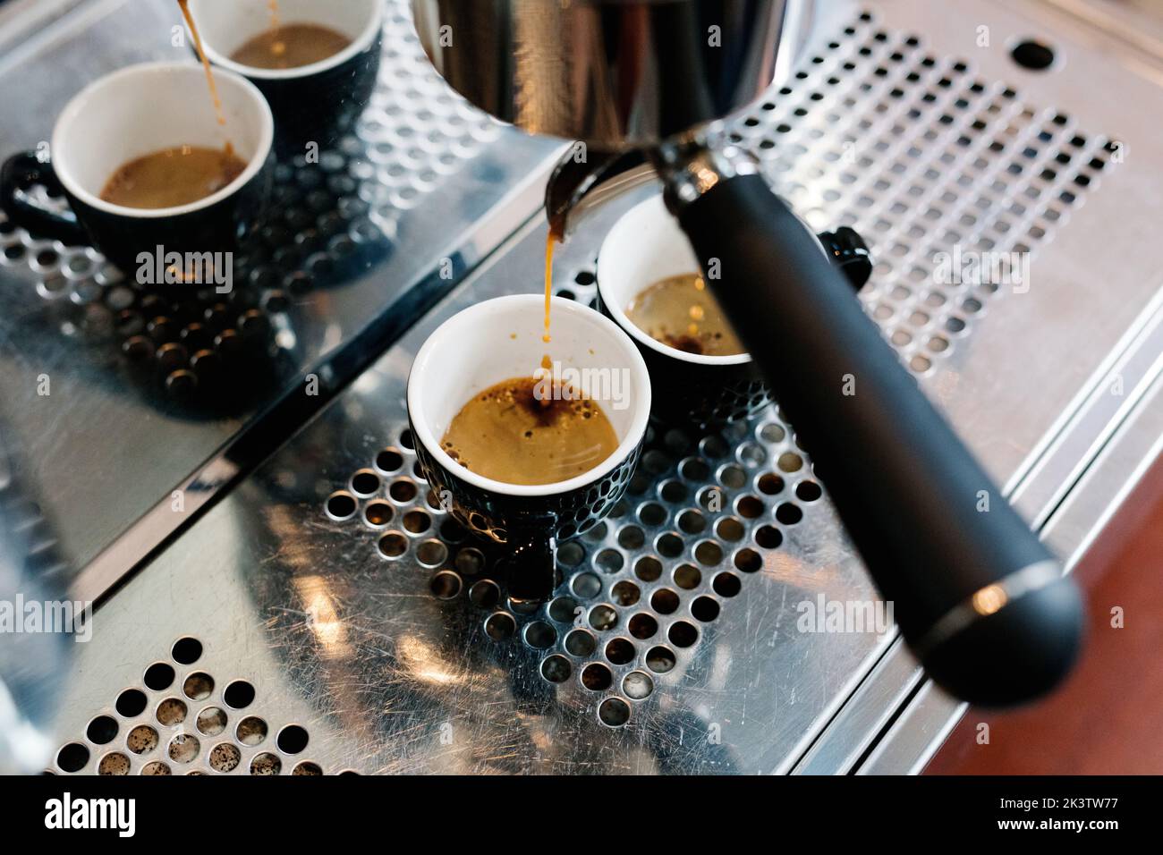 From above freshly aromatic coffee in compartment at coffee machine ...