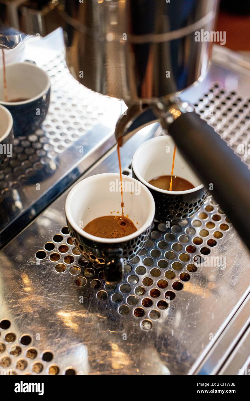 From above freshly aromatic coffee in compartment at coffee machine ...