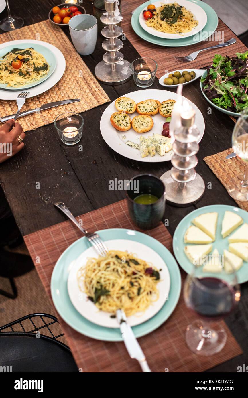 From above of wooden table served with traditional Italian dishes and ...