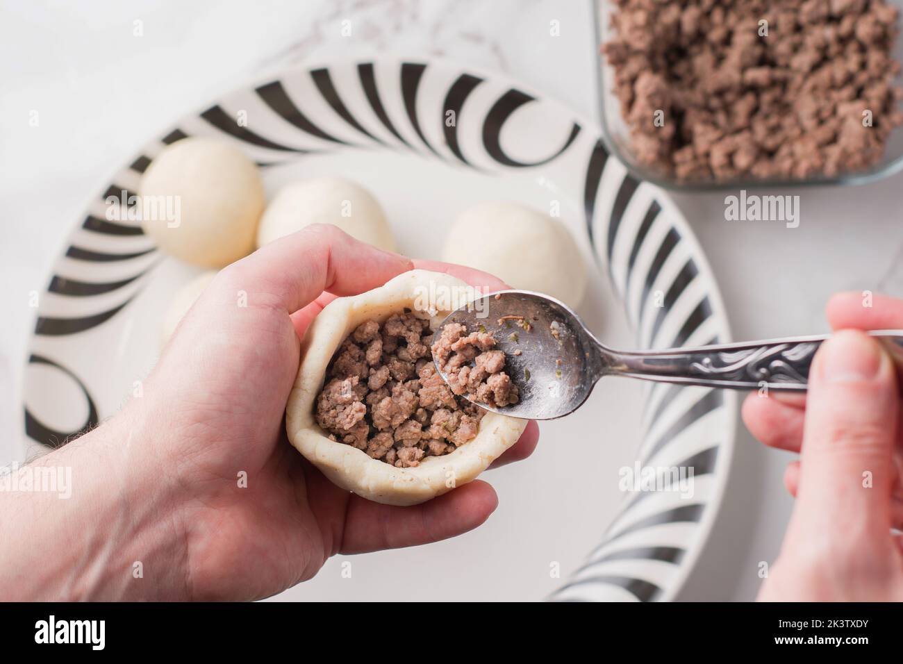 From above of crop anonymous female with spoon adding ground meat in ...