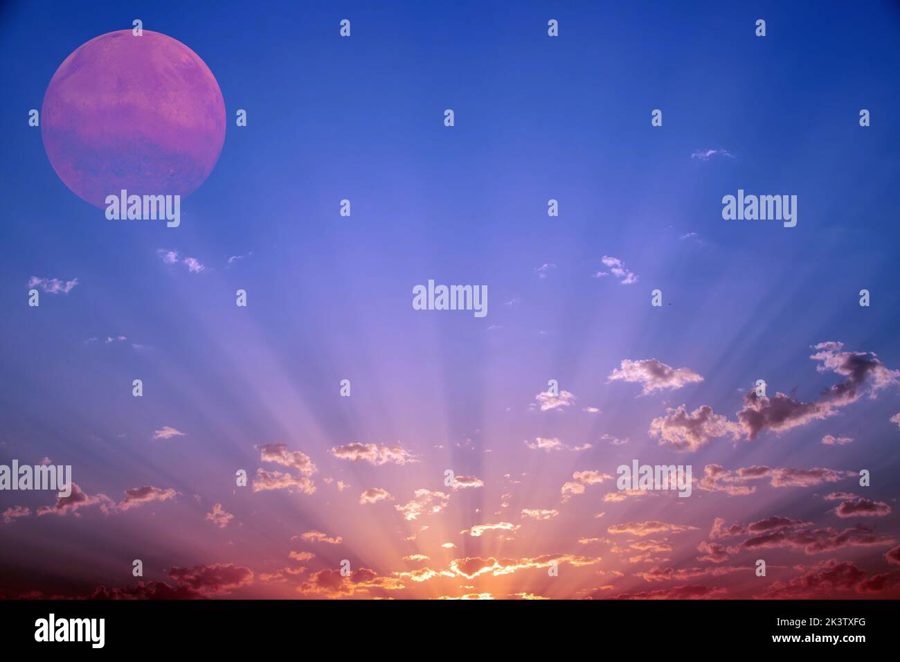 A scenic view of the rays of the sun with the full moon in the clear ...