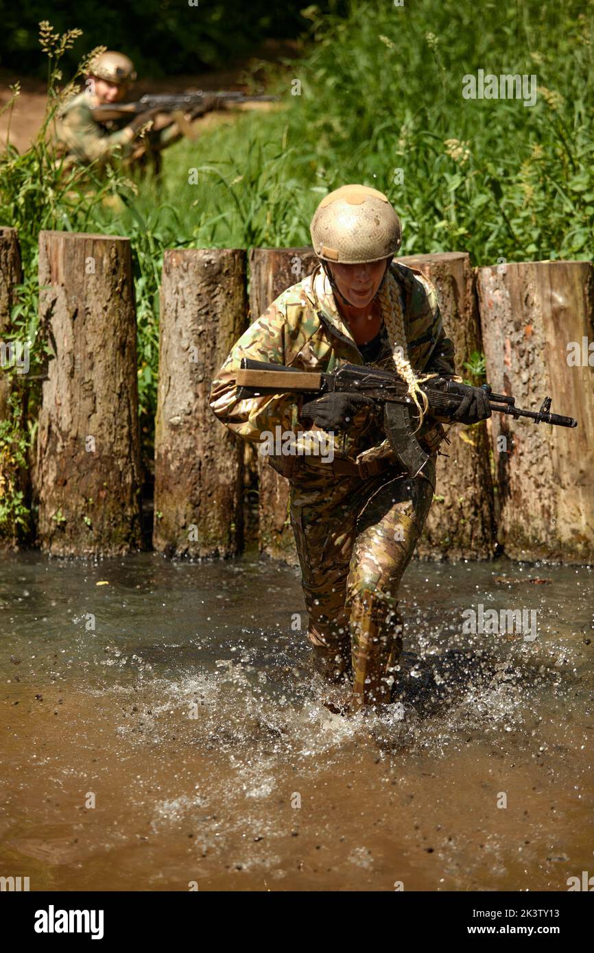 Special forces soldier with weapon take part in military maneuver. War ...