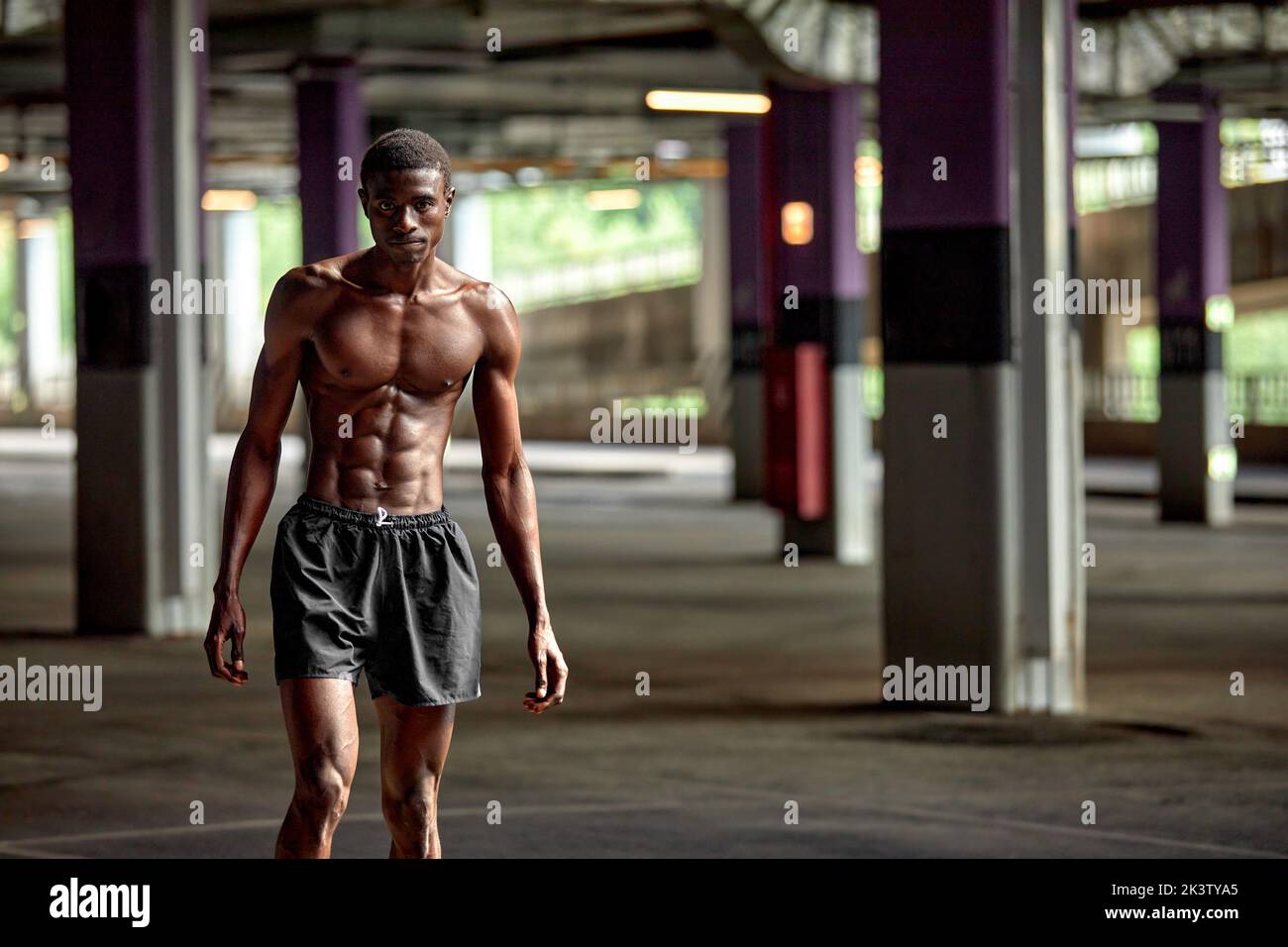 Handsome African American sportman standing on the street while taking ...