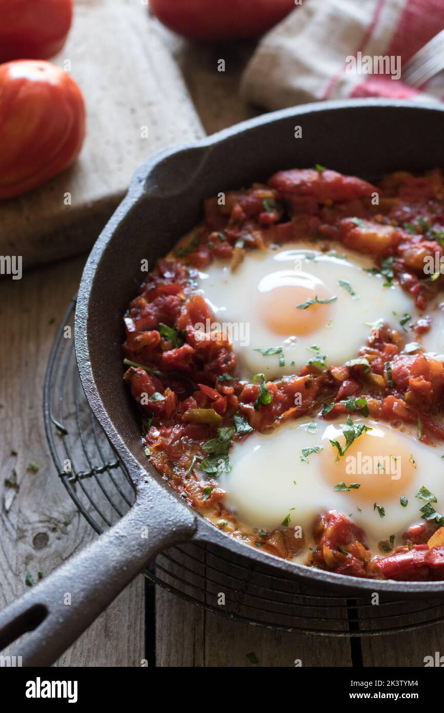 Top view of served frying pan with delicious shakshuka dish on table ...